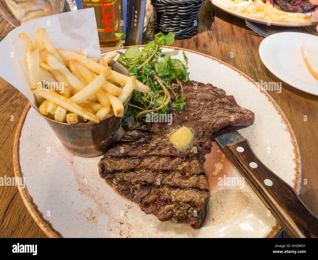 Lunchtime flattened pan-seared bavette Steak served with French fried ...