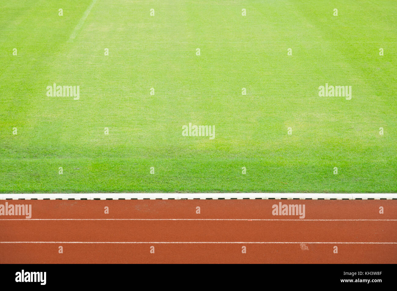 Running track with gree field Stock Photo - Alamy