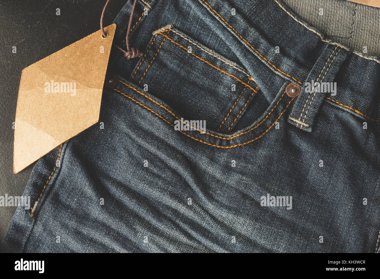 Blue jeans detail with blank tag Stock Photo - Alamy
