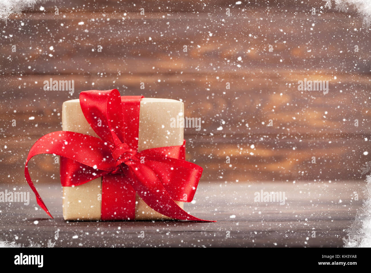 Christmas gift box in front of wooden wall with space for your ...