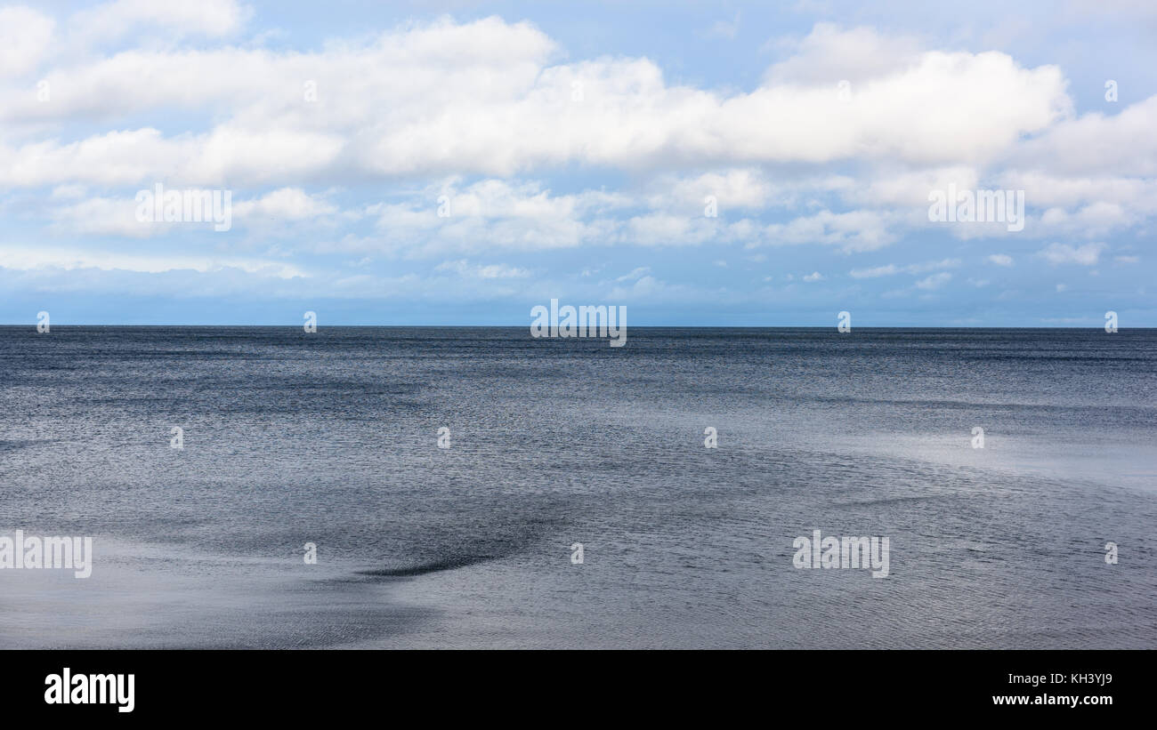 Shoreline of Baltic sea beach with rocks and sand dunes under clouds ...
