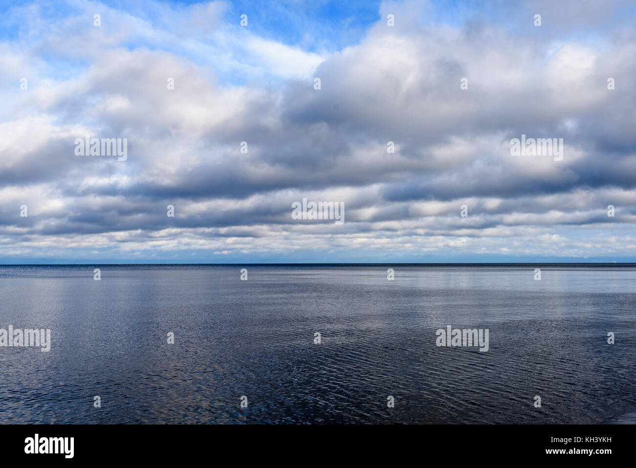 Shoreline of Baltic sea beach with rocks and sand dunes under clouds ...