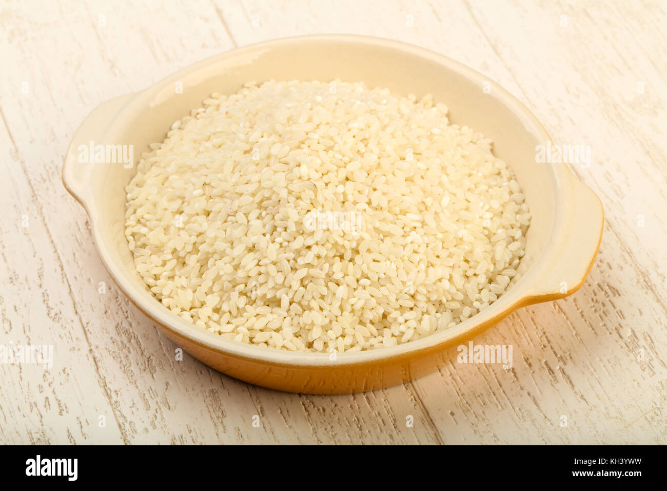 Raw rice heap in the bowl - ready for cooking Stock Photo - Alamy