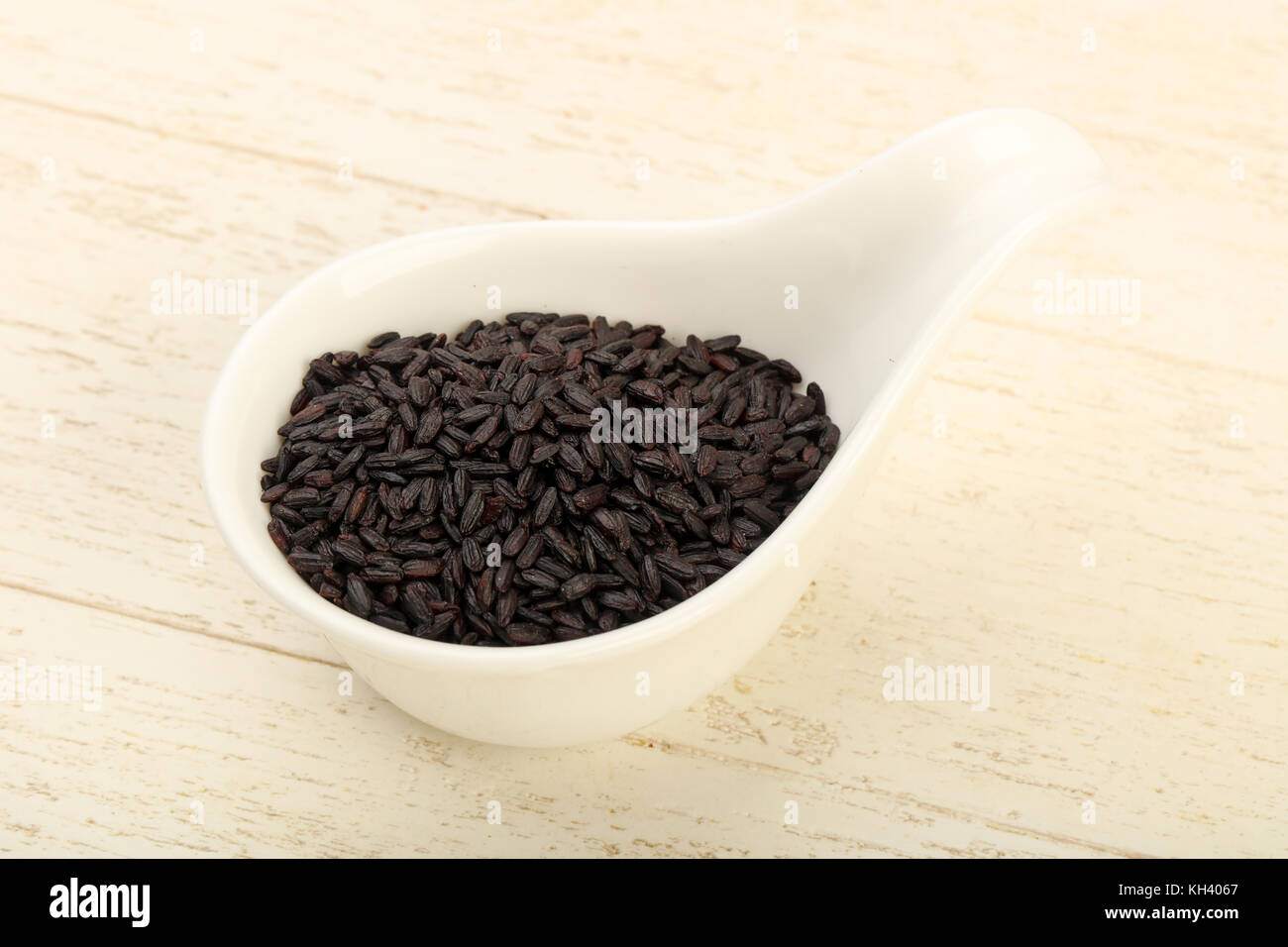 Black wild rice in the bowl over wooden background Stock Photo - Alamy