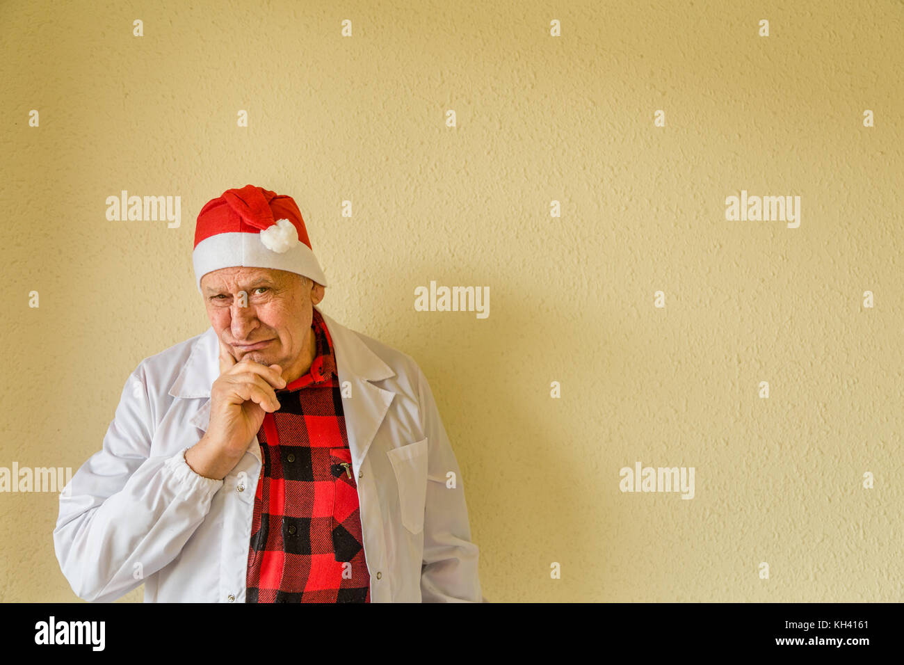 sad old doctor with white medical gown and checkered shirt wearing ...