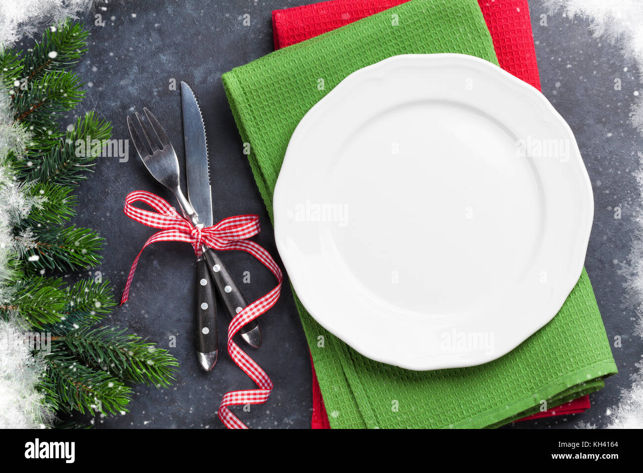 Christmas dinner plate, silverware, fir tree. Top view with copy space ...