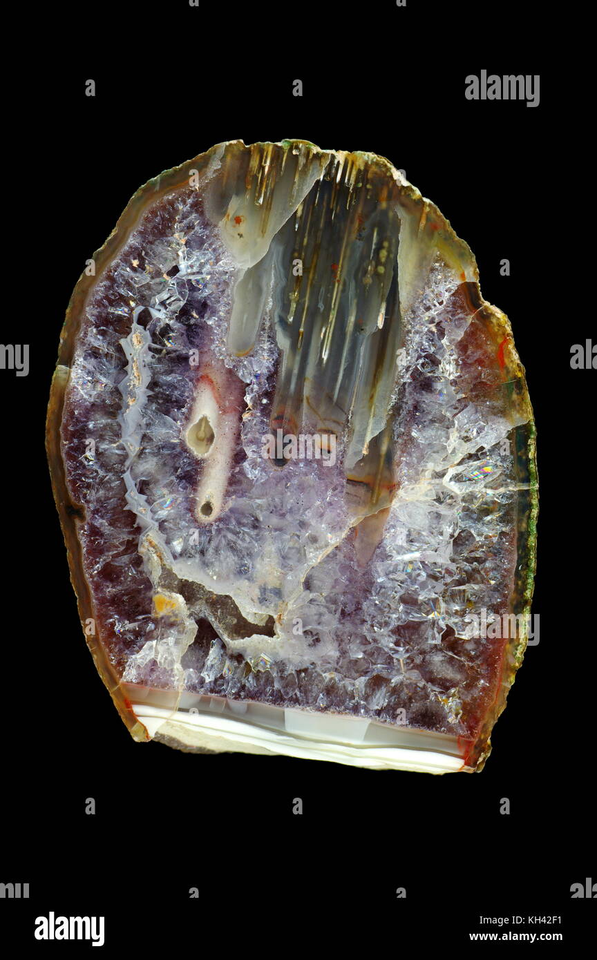 A cross section of silk-filled, stalactite agate stone. Multicolored ...