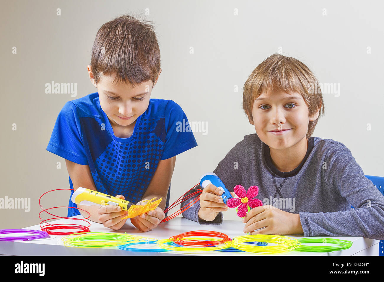 Two boys creating with 3d printing pen Stock Photo - Alamy