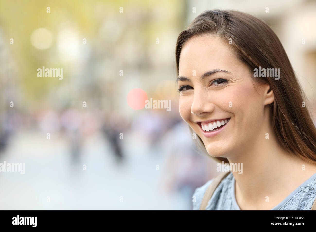 Portrait of a happy woman with perfect smile posing on the street Stock ...