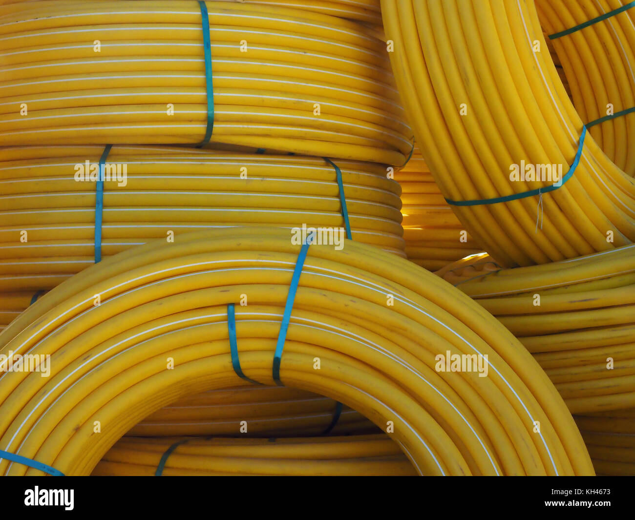 Cable bright yellow, folded into huge coils, bundles that lie together ...