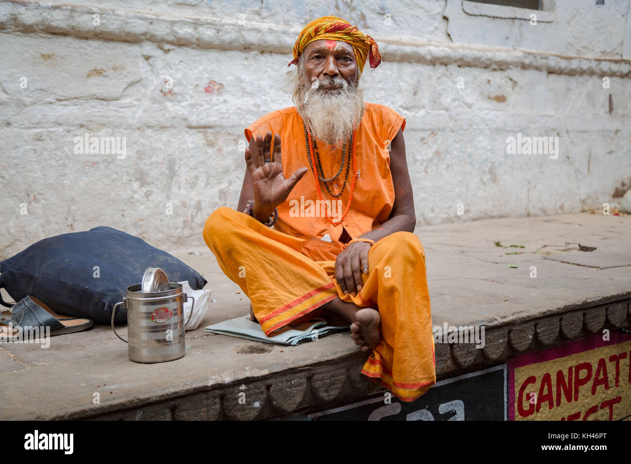 Sadhu baba pose raising the blessing hand at the Ganga river bank in ...