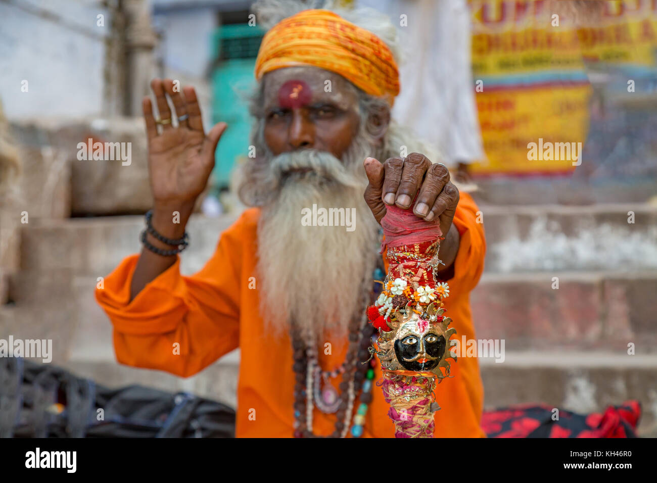 Sadhu baba pose raising the blessing hand at the Ganga river bank in ...