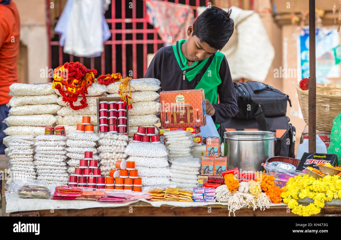 Cute Indian boy child sell sweets for puja offerings at the Ganges ...