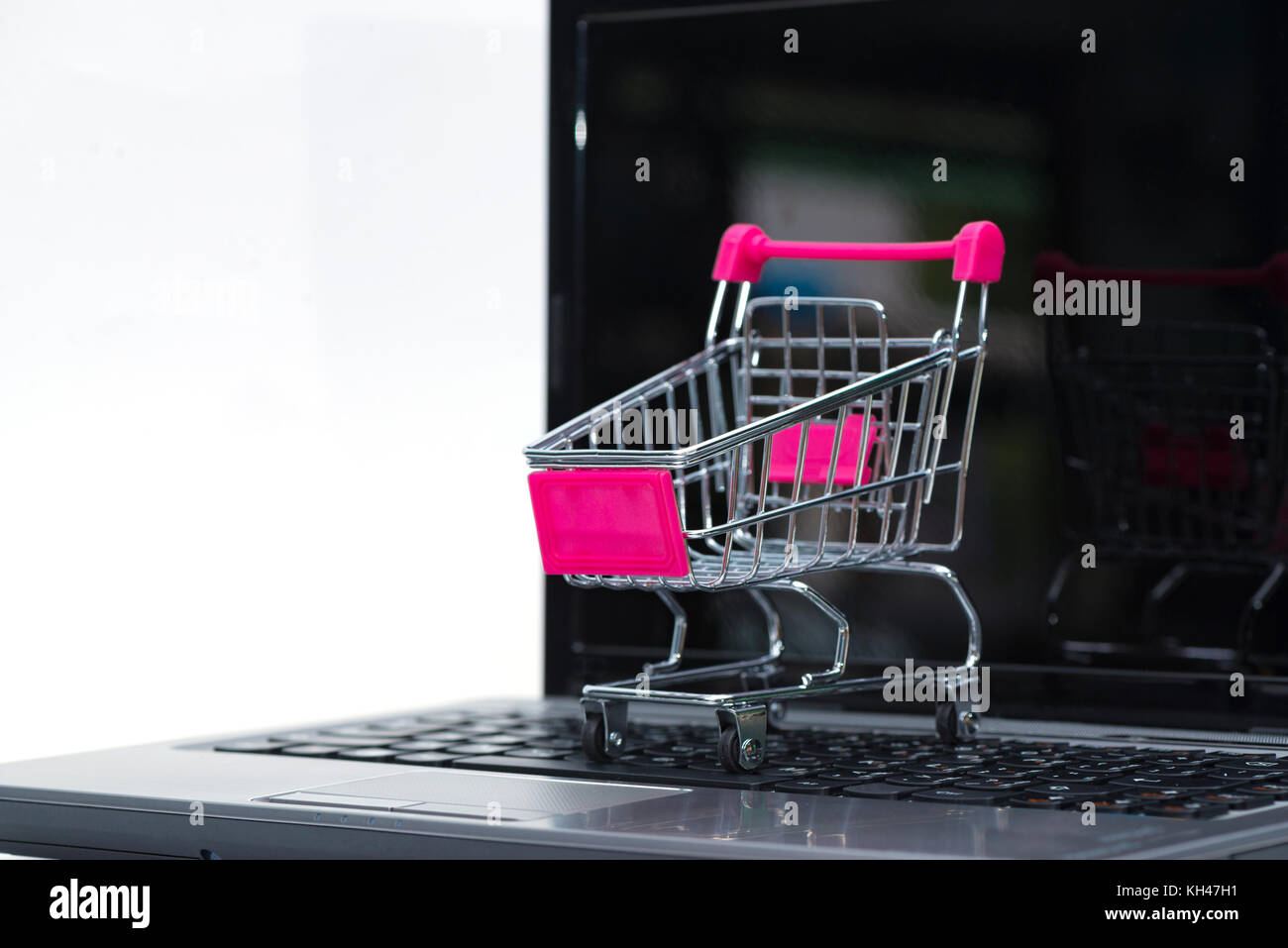 Shopping cart or supermarket trolley with laptop notebook on white ...