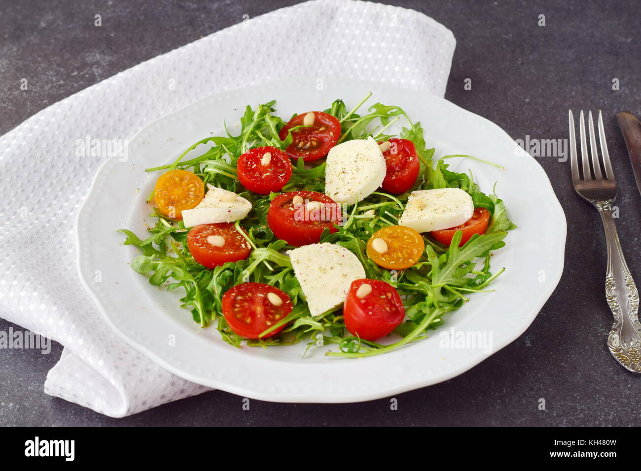 Traditional Italian salad with cherry tomato, ruccola, mozzarella ...