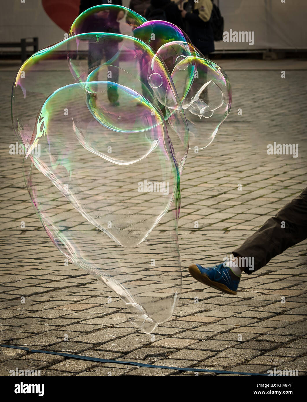 Leg of a young boy kicking big soap bubbles Stock Photo - Alamy