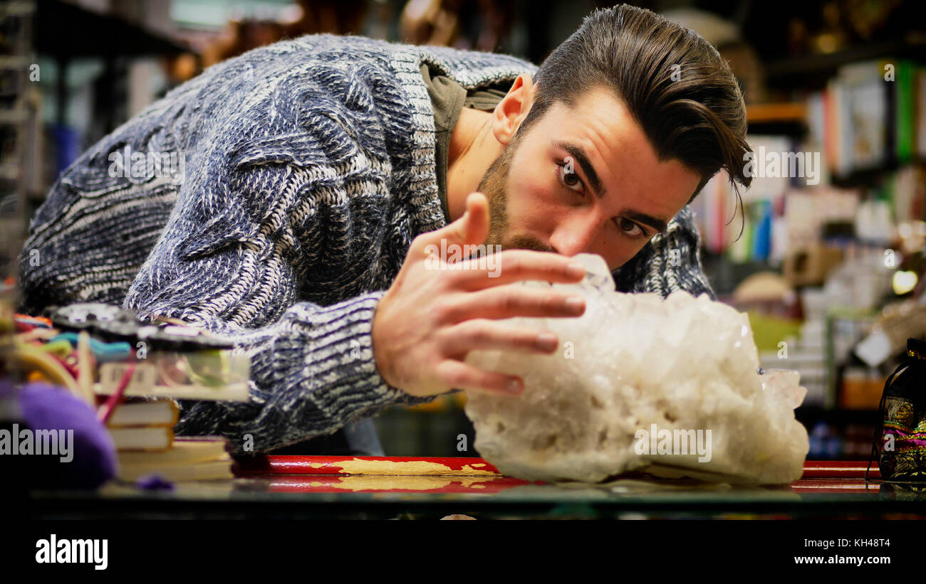 Man looking at goods in shop, big quartz crystal Stock Photo - Alamy