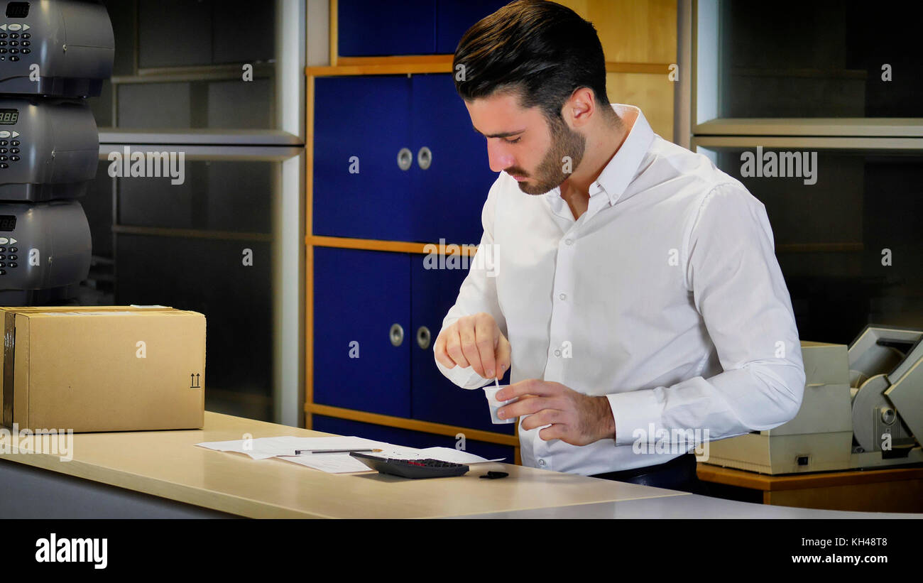 Man looking at documents Stock Photo - Alamy