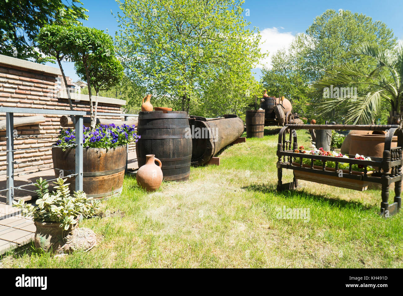 Atmospheric Georgian garden with barrels and needle jugs Stock Photo ...