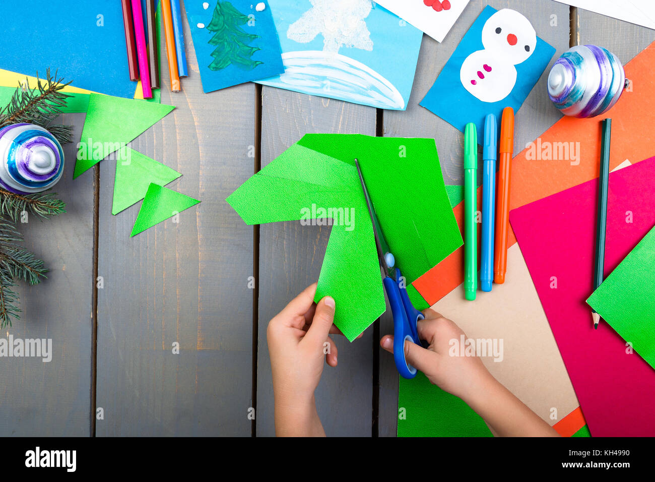 Child hands make handmade christmas toys from cardboard. Children's DIY ...