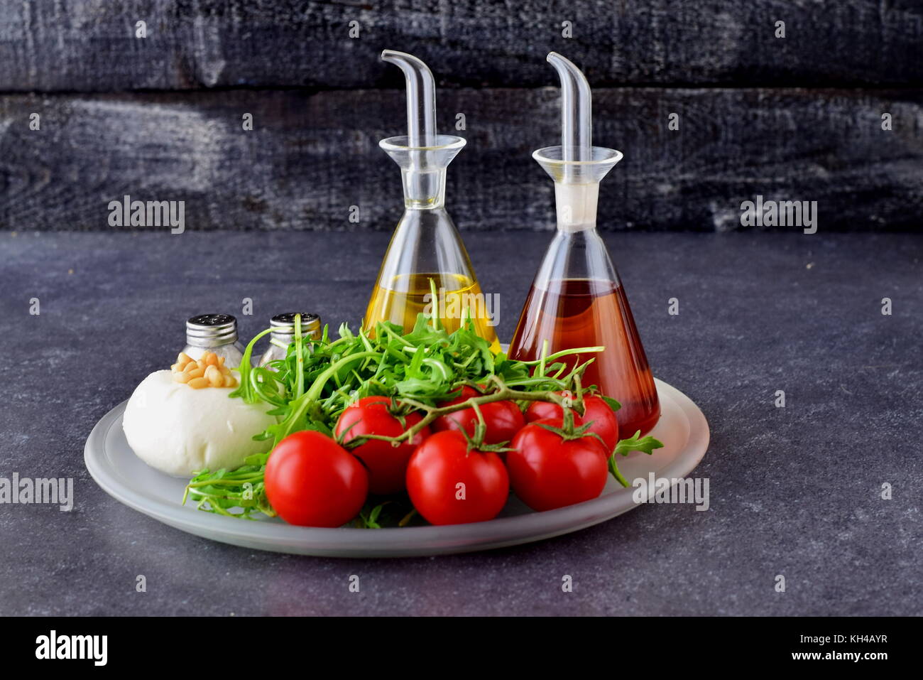 Ingredients for the traditional Italian caprese salad on a glass tray ...