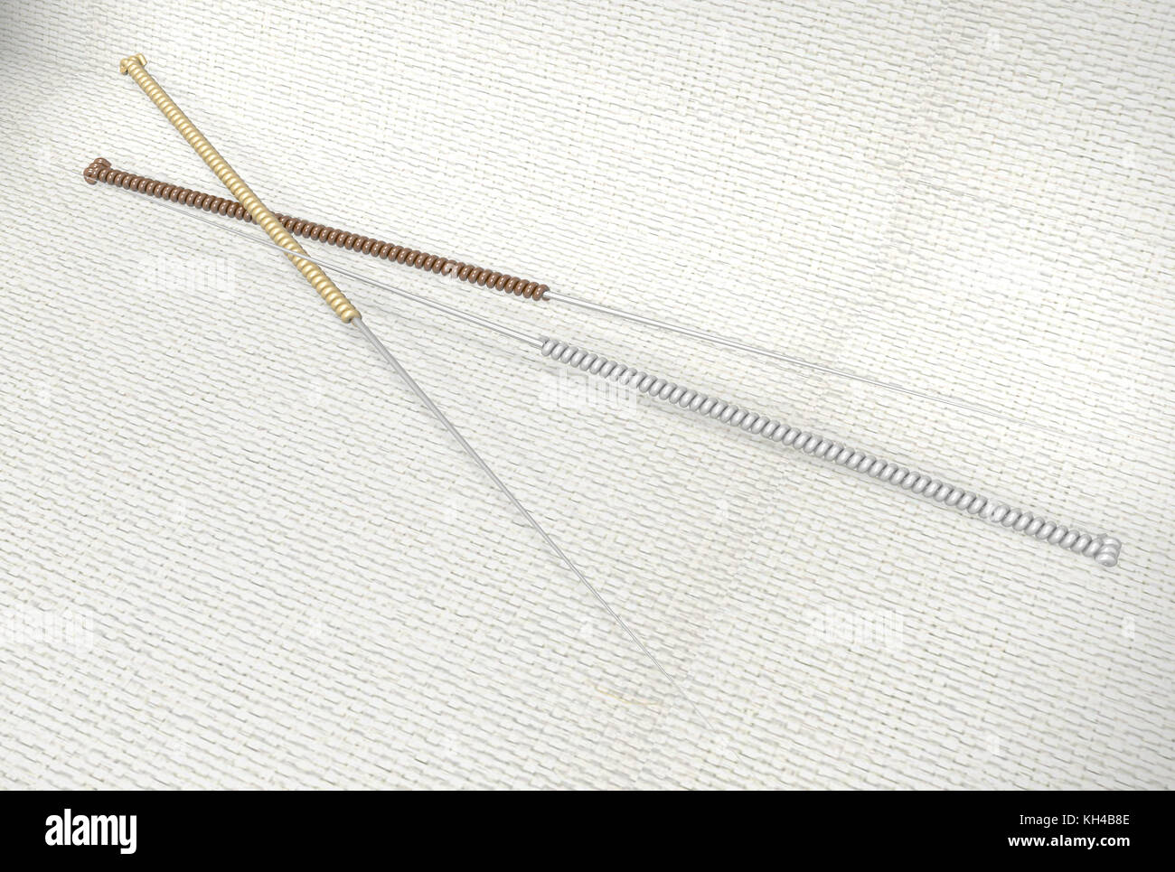 three acupuncture needles on fabric bckground Stock Photo - Alamy