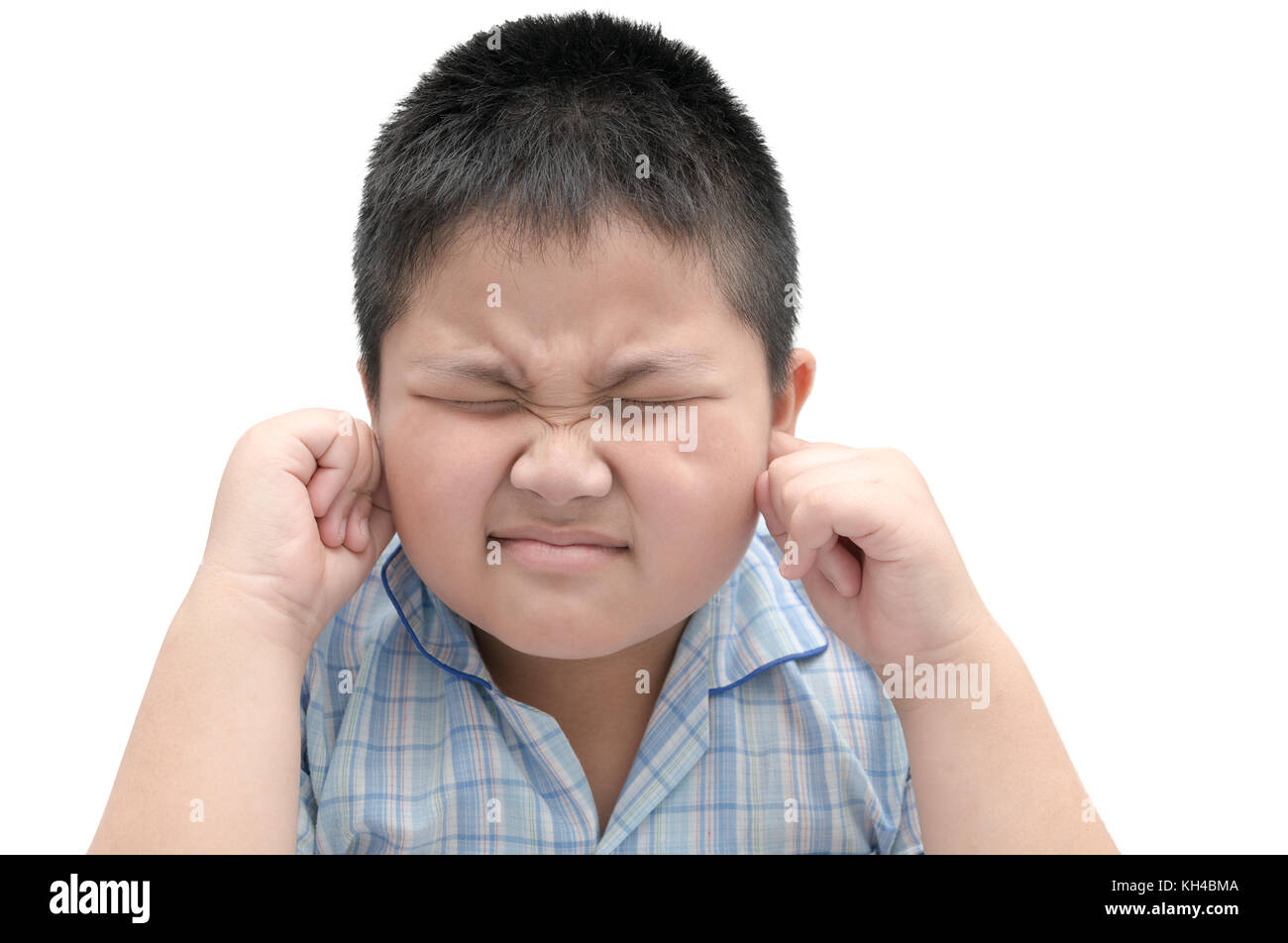obese fat boy closes ears with fingers to protect from loud noise ...