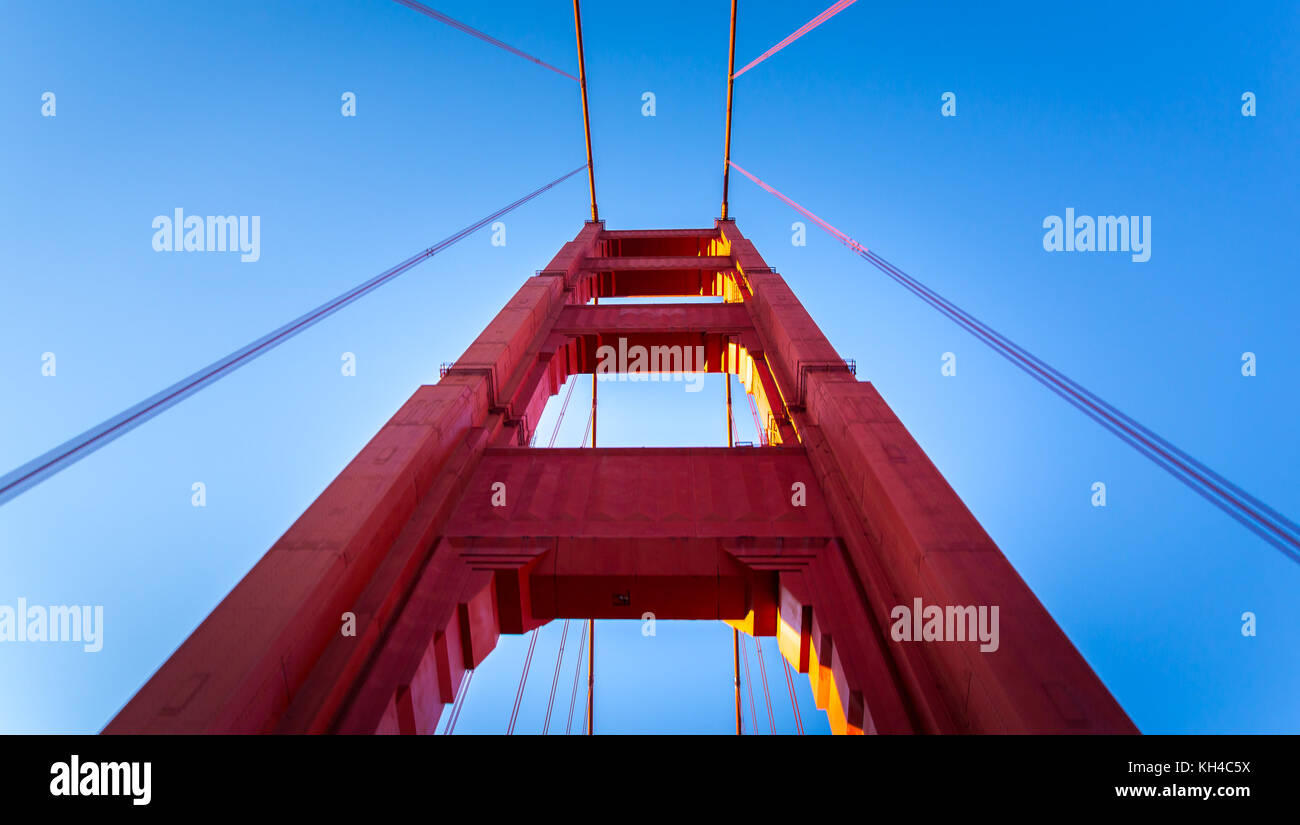 Looking up at the red tower and suspension cables of the Golden Gate ...