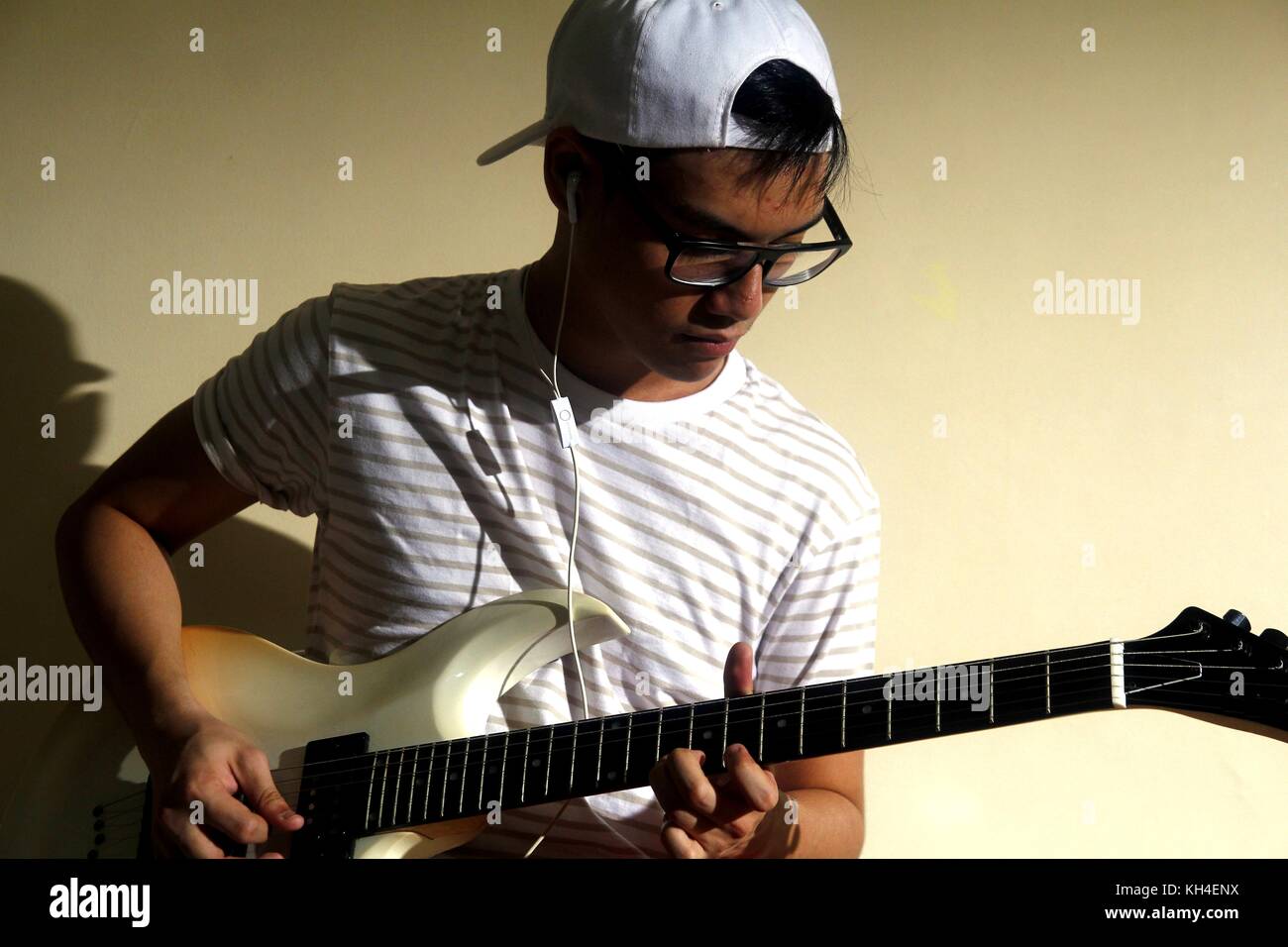 Photo of a teen playing an electric guitar Stock Photo - Alamy