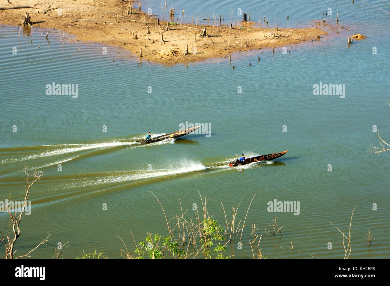 Two man moving fast forward on motor boat as boat race, boat make wave ...