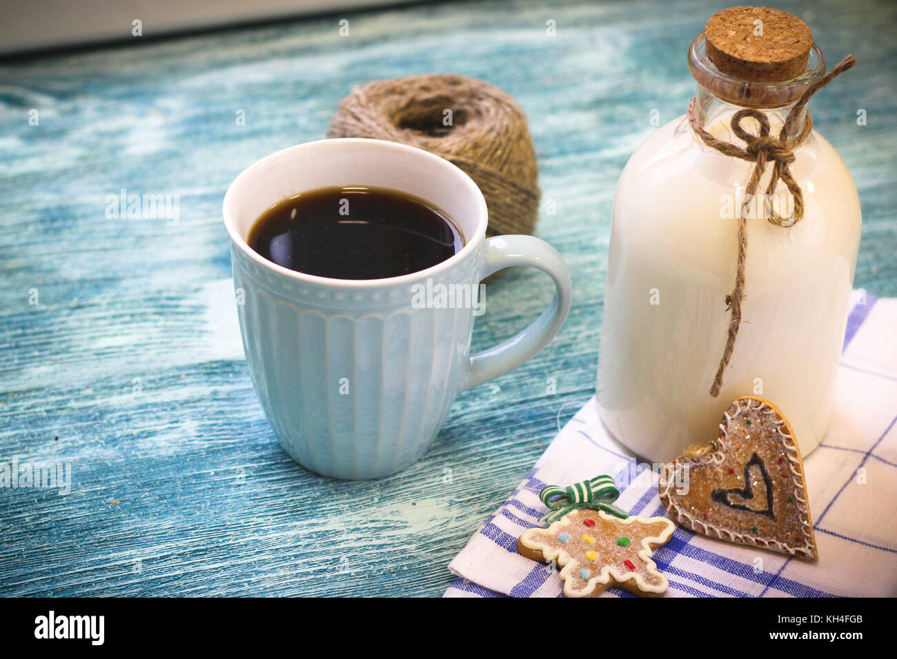 Festive still life with a bottle, a cup, biscuits Stock Photo - Alamy