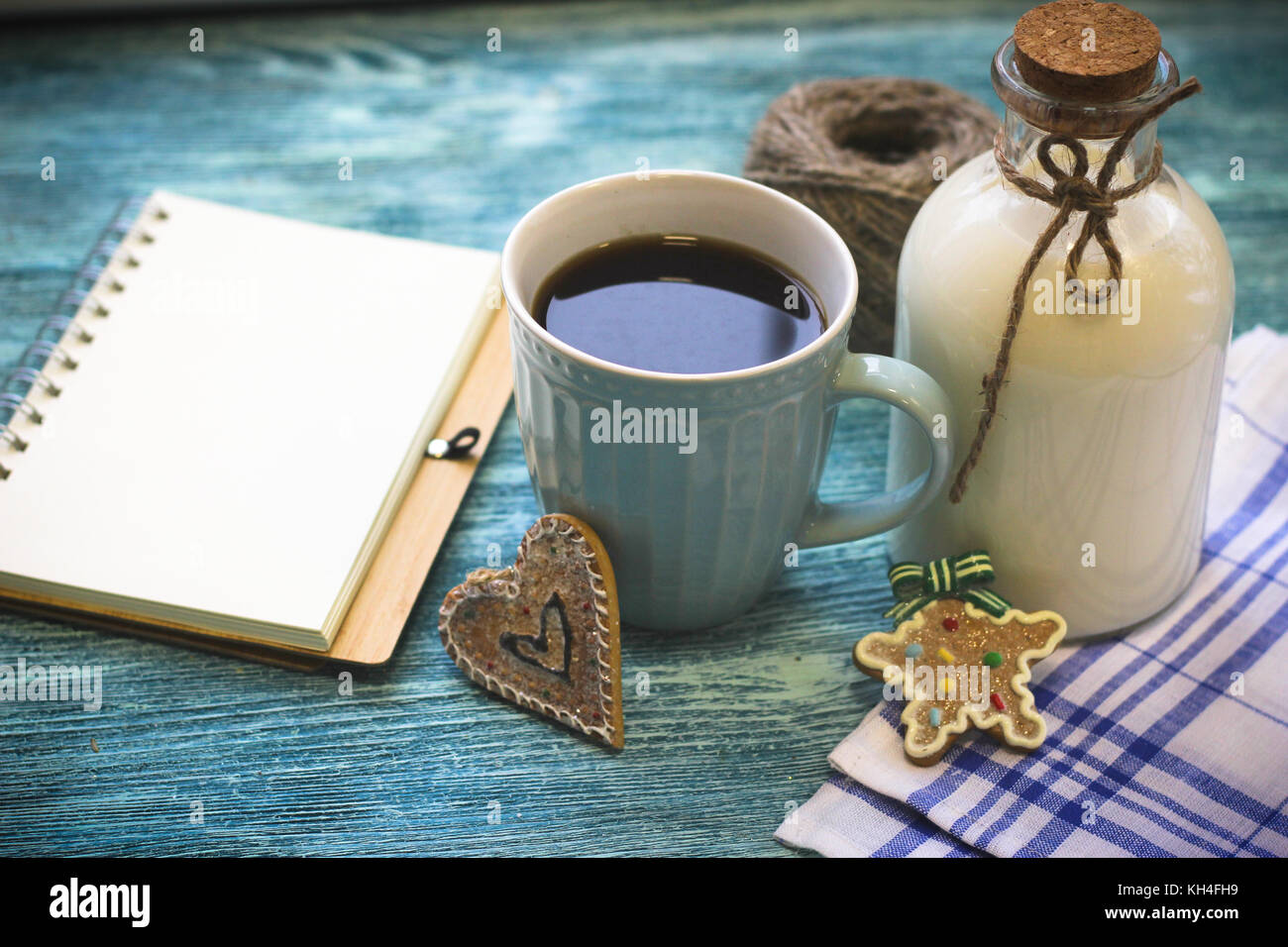Festive still life with a bottle, a cup, a notebook Stock Photo - Alamy