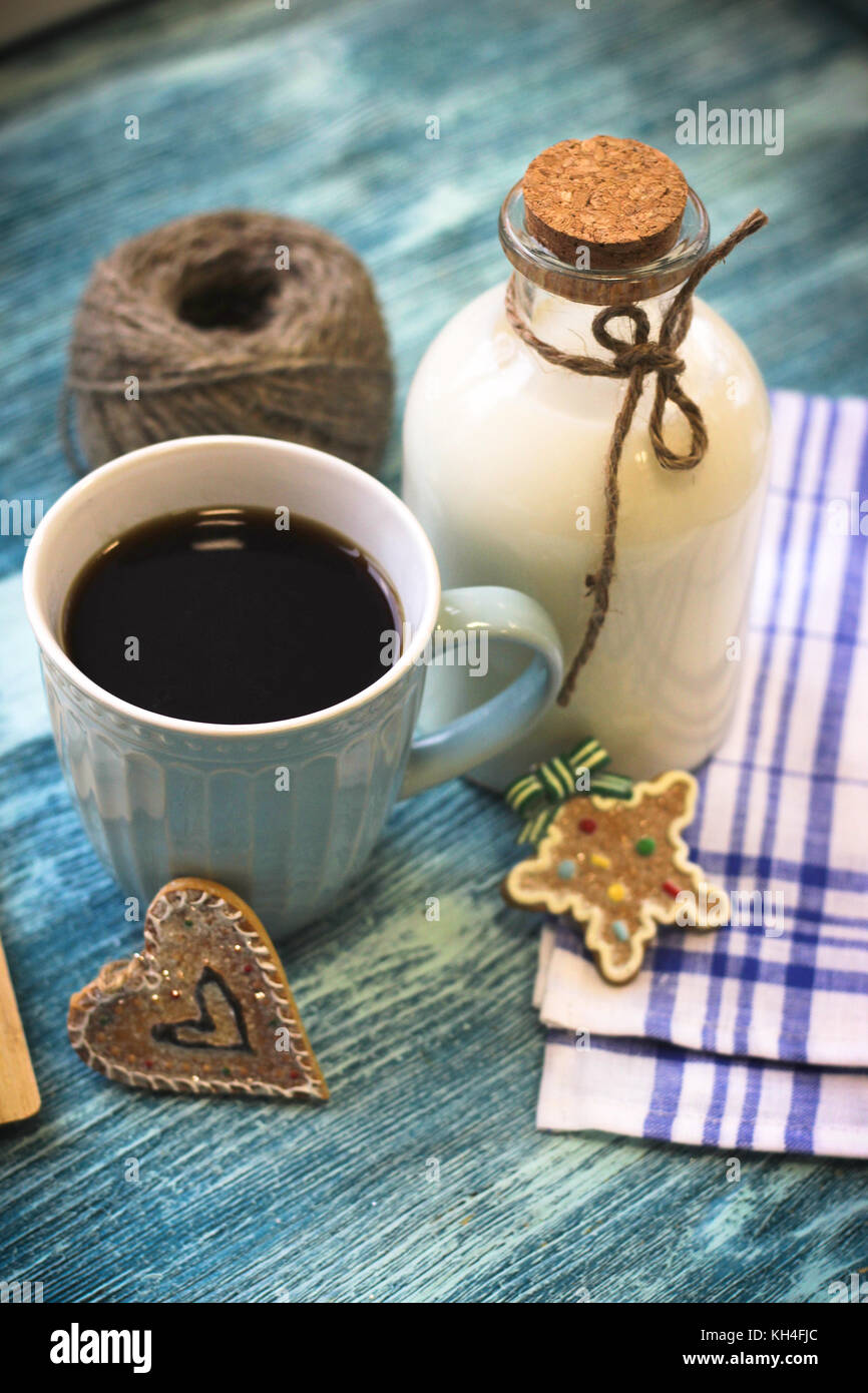 Festive still life with a bottle, a cup, biscuits Stock Photo - Alamy