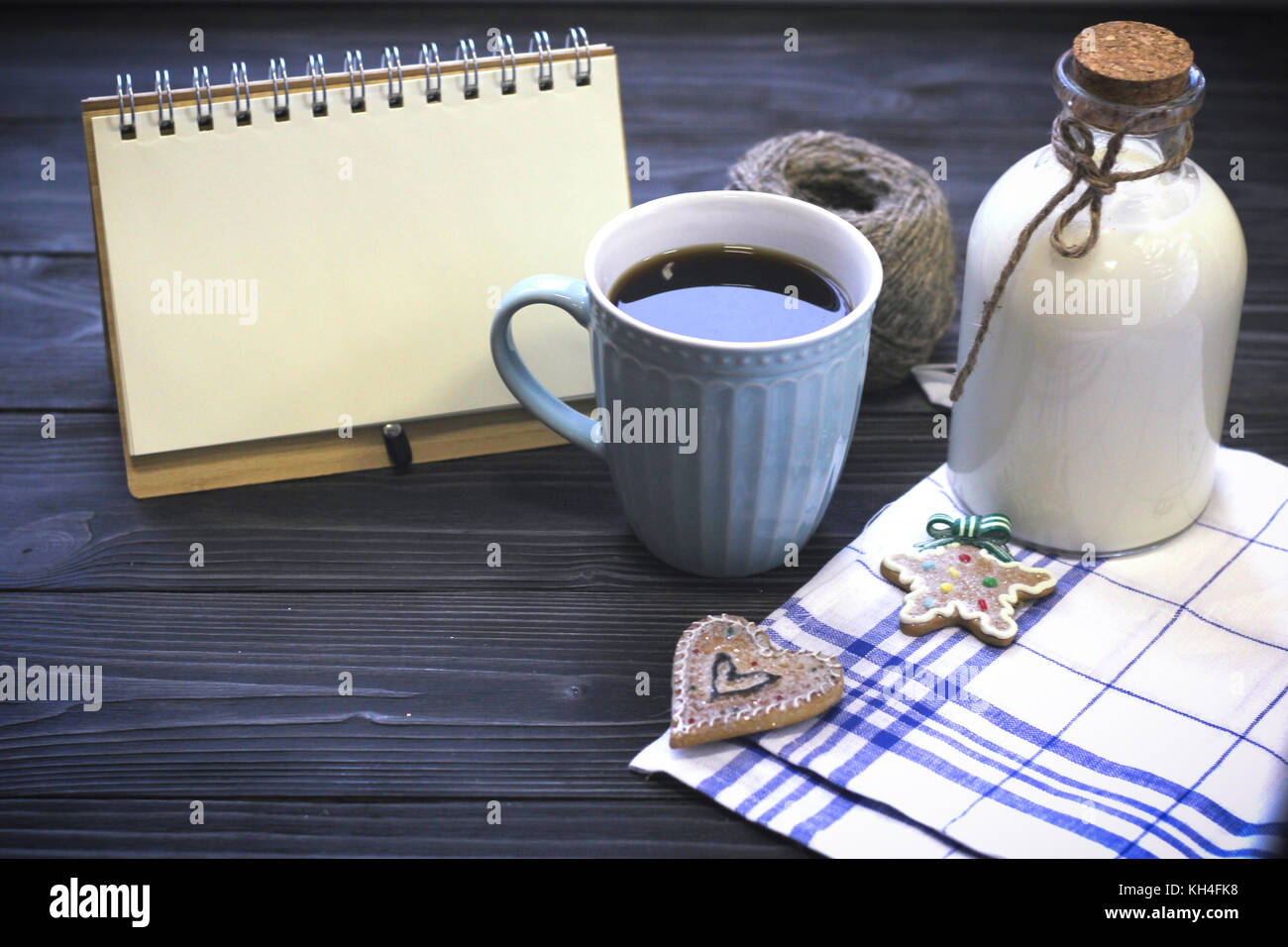 Festive still life with a bottle, a cup, a notebook Stock Photo - Alamy