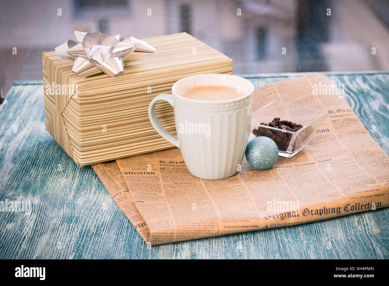 Festive still life with box, cup, vase, ball, newspaper Stock Photo - Alamy