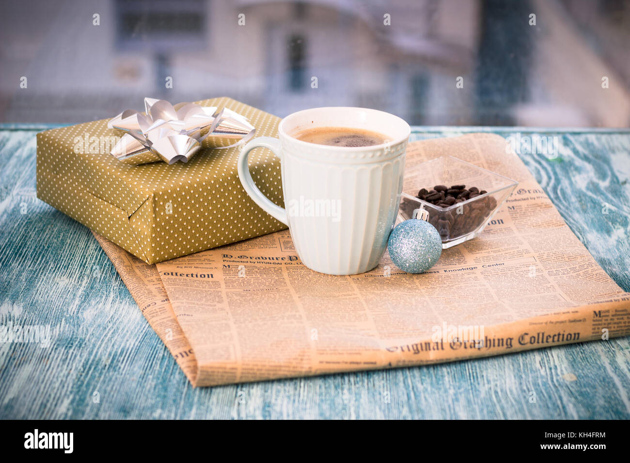 Festive still life with box, cup, vase, blue ball, newspaper Stock ...