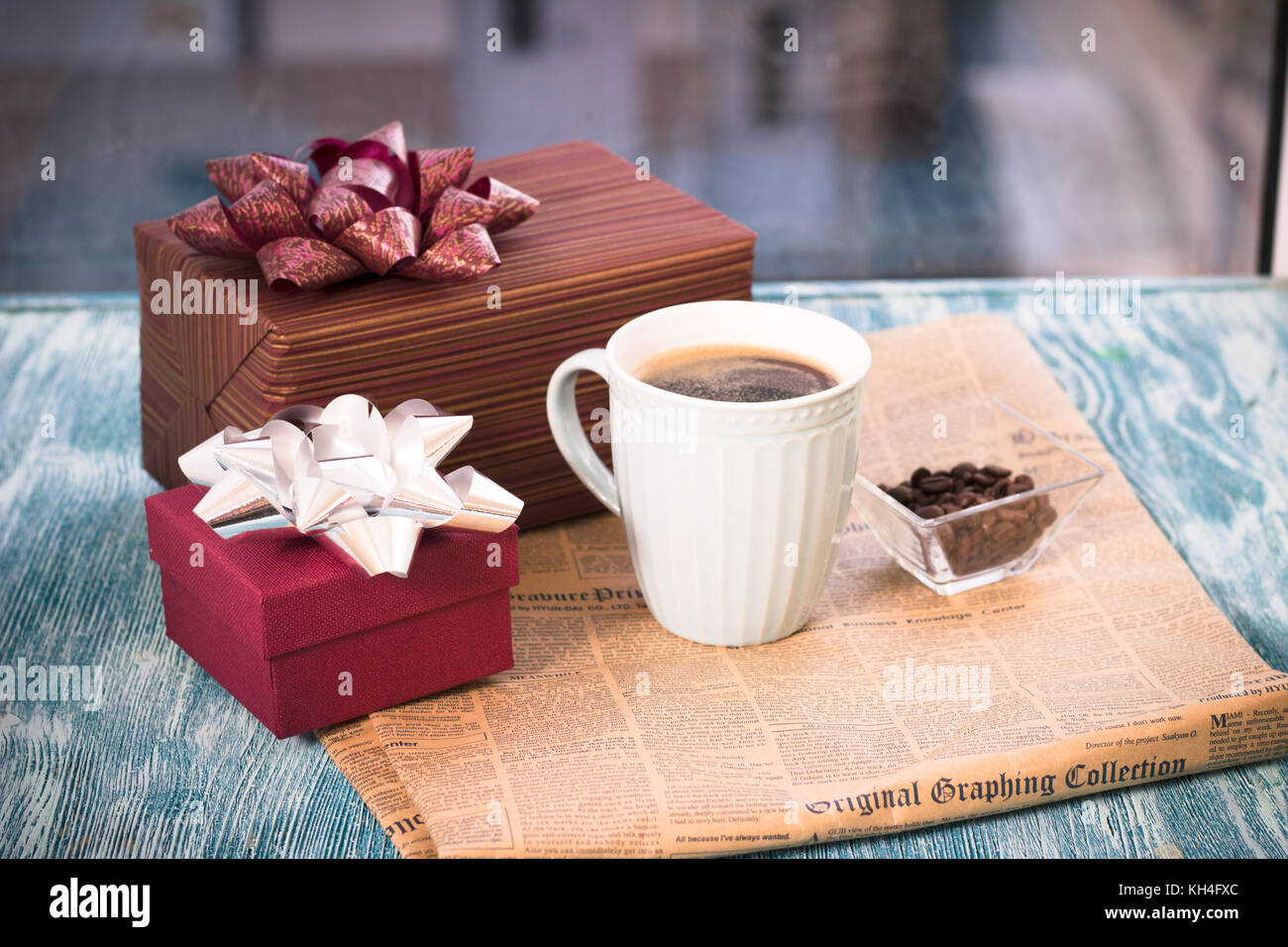 Festive still life with gifts, a cup, a vase and a newspaper Stock ...