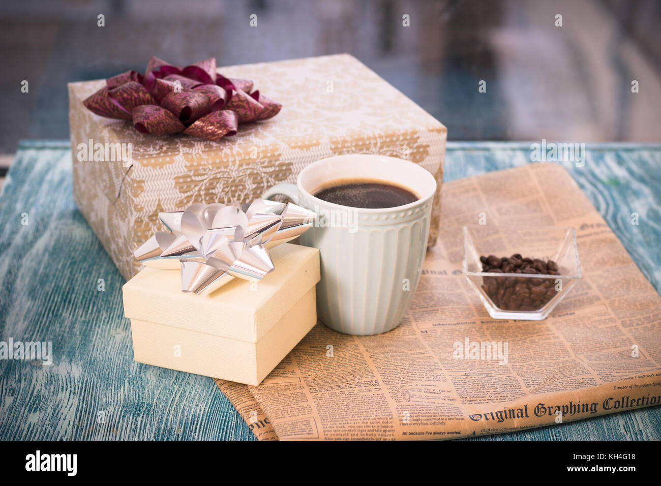 Festive still life with gifts, a cup, a vase and a newspaper Stock ...