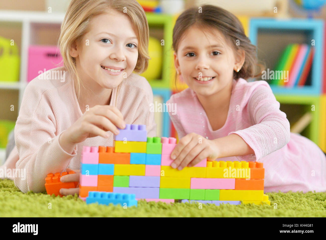 girls playing with colorful blocks Stock Photo - Alamy