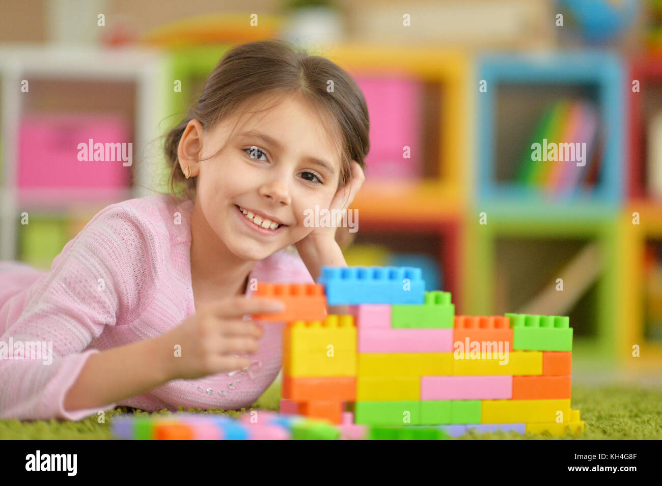 little girl with colorful plastic blocks Stock Photo - Alamy