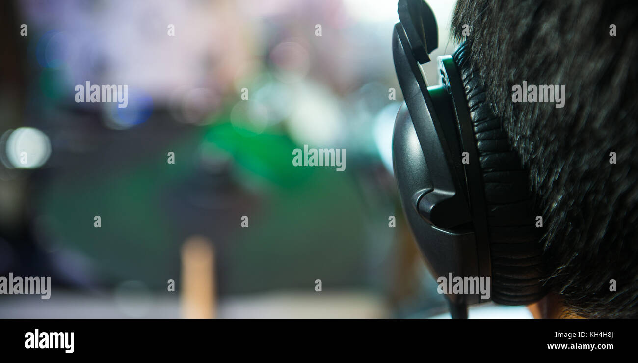 Back view of a young man listening music with headphones, France Stock ...