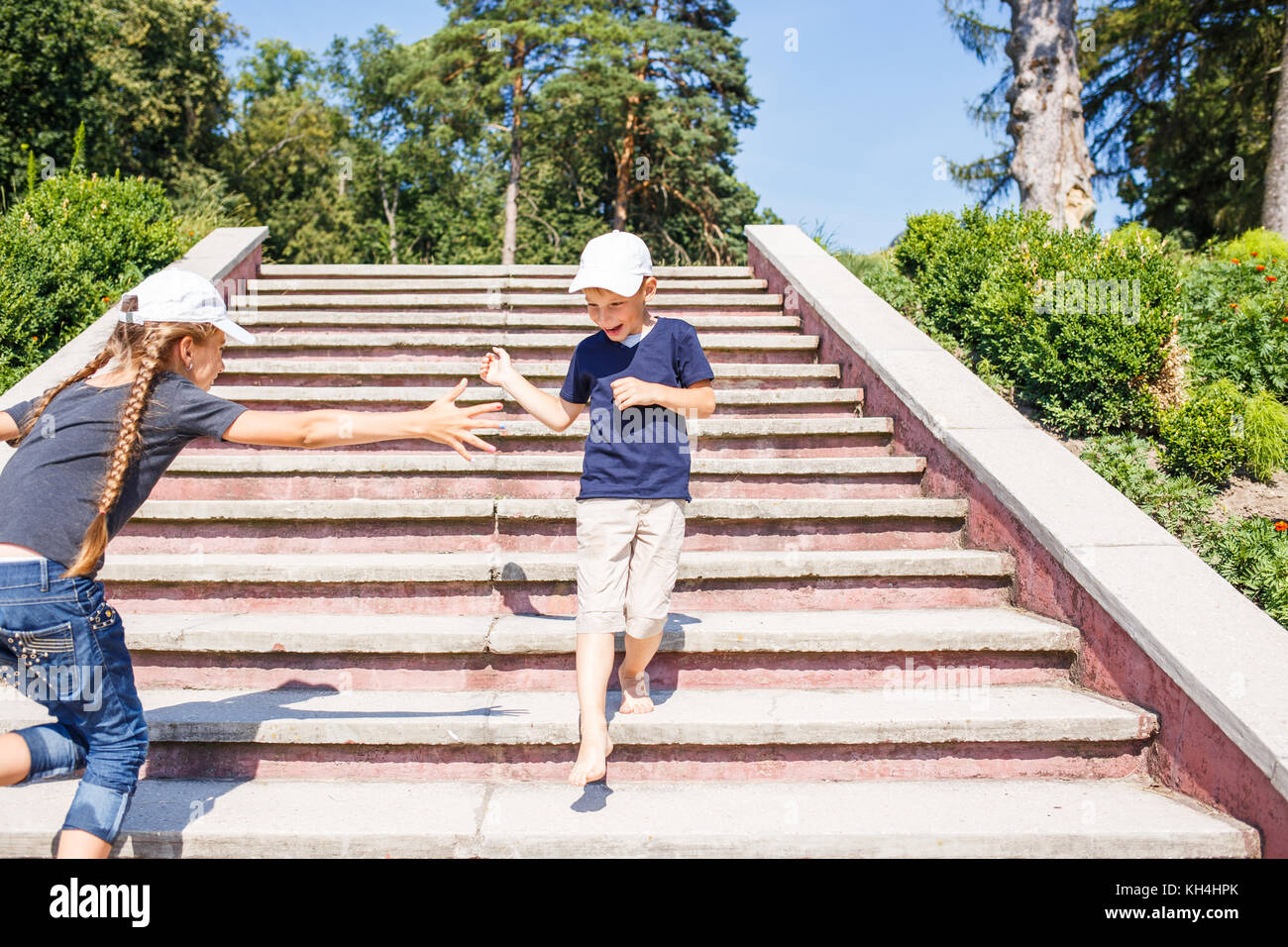 Children rushing down on stairs barefoot. Concept childhood image with ...