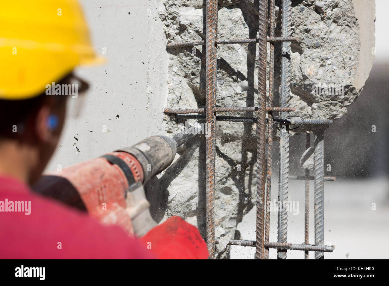 Construction worker using a drilling power tool Stock Photo - Alamy