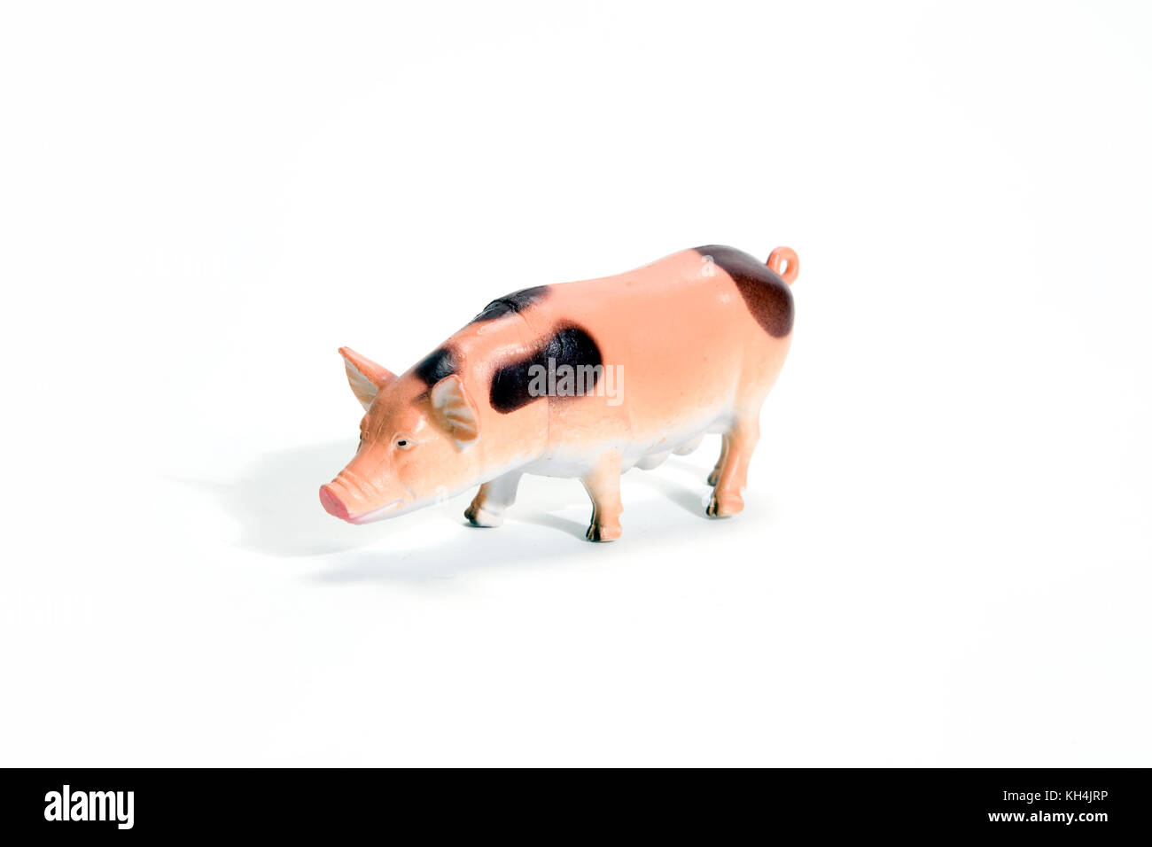 pink pig plastic figurine toy on a white background. Minimal still life ...