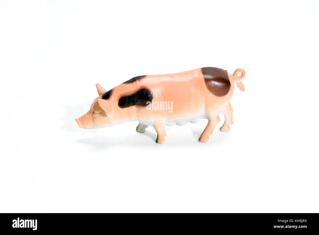 pink pig plastic figurine toy on a white background. Minimal still life ...