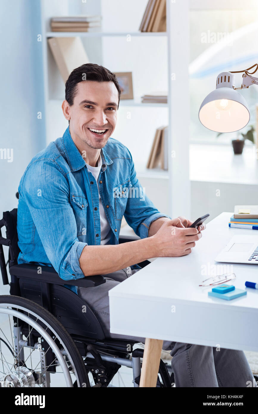 Handsome invalid freelancer looking at camera Stock Photo - Alamy