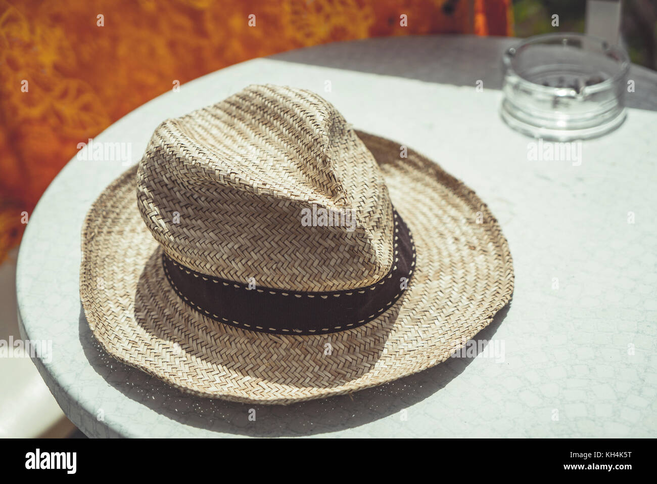 old straw hat on a table Stock Photo - Alamy