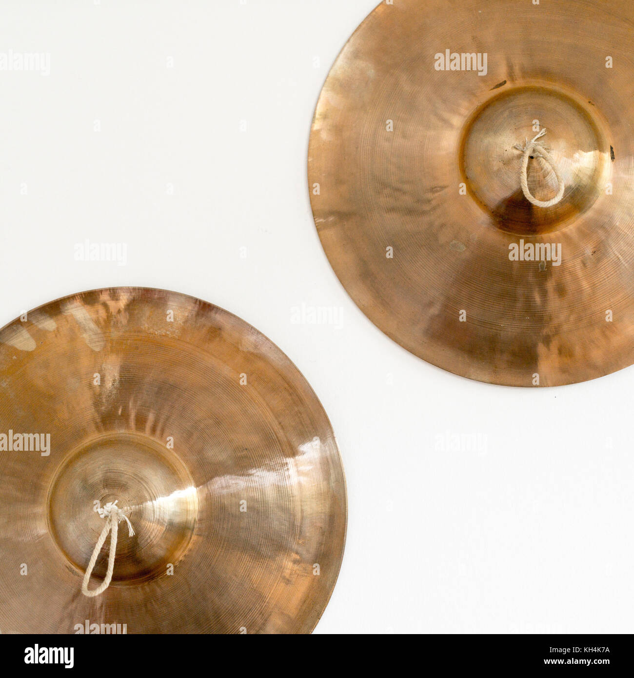 tow old Tibetan cymbals on a white wall Stock Photo - Alamy