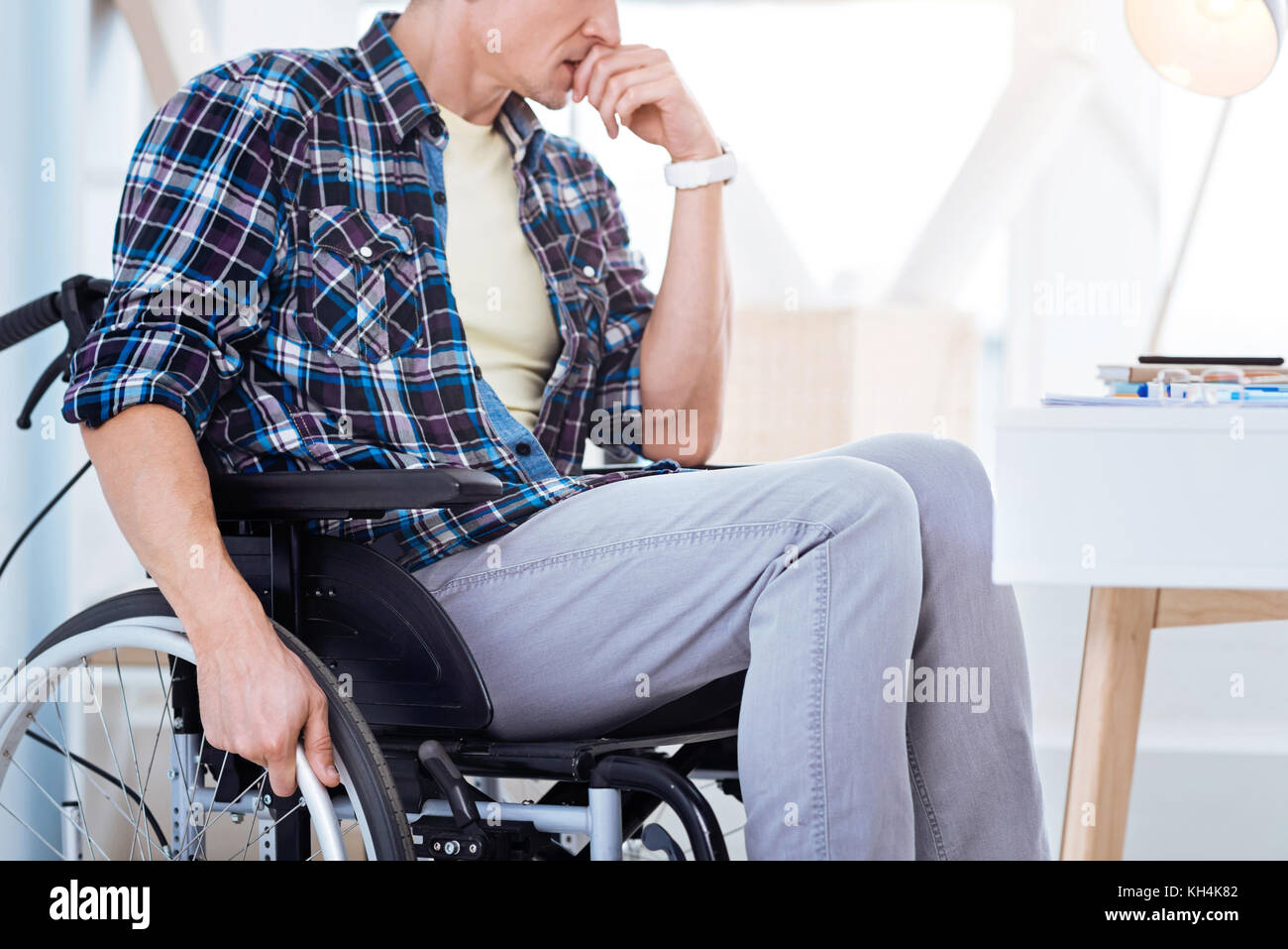 Serious disabled male person sitting on his wheelchair Stock Photo - Alamy