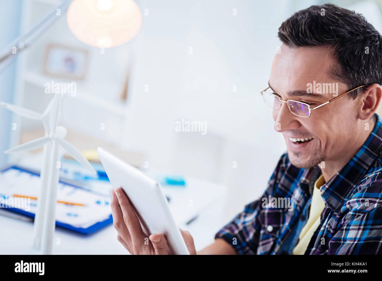 Joyful male person playing with new gadget Stock Photo - Alamy